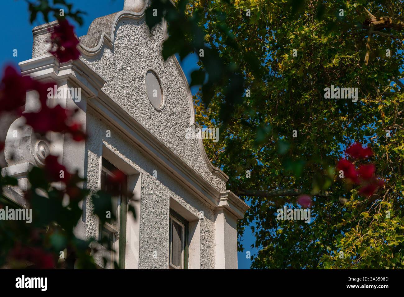 Beautiful colonial facade in white color on Dorp street, famous alley ...