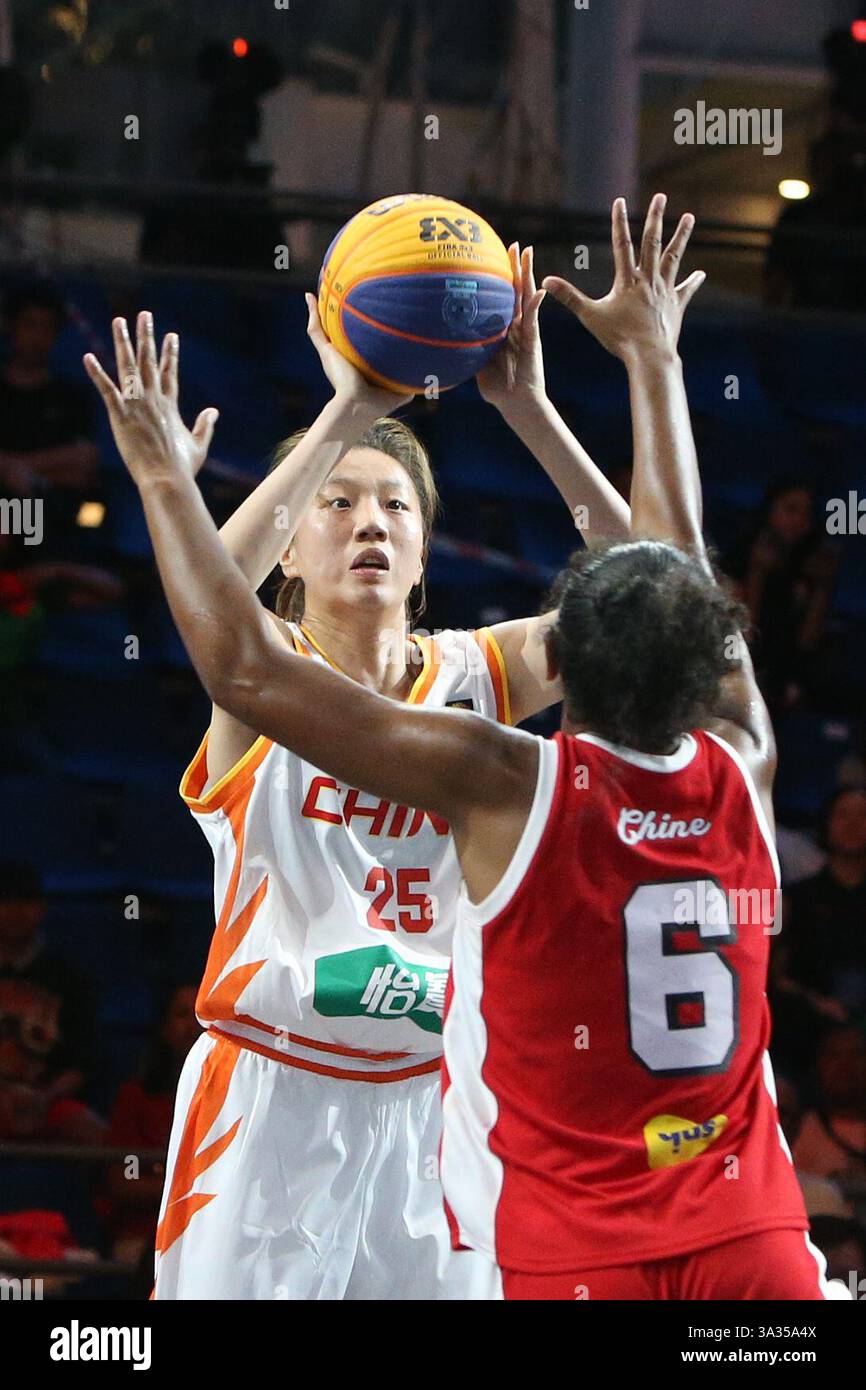 Bangkok, Thailand. 14th Mar, 2025. Li Yuyan (L) of China shoots the ball during a Pool A match ...