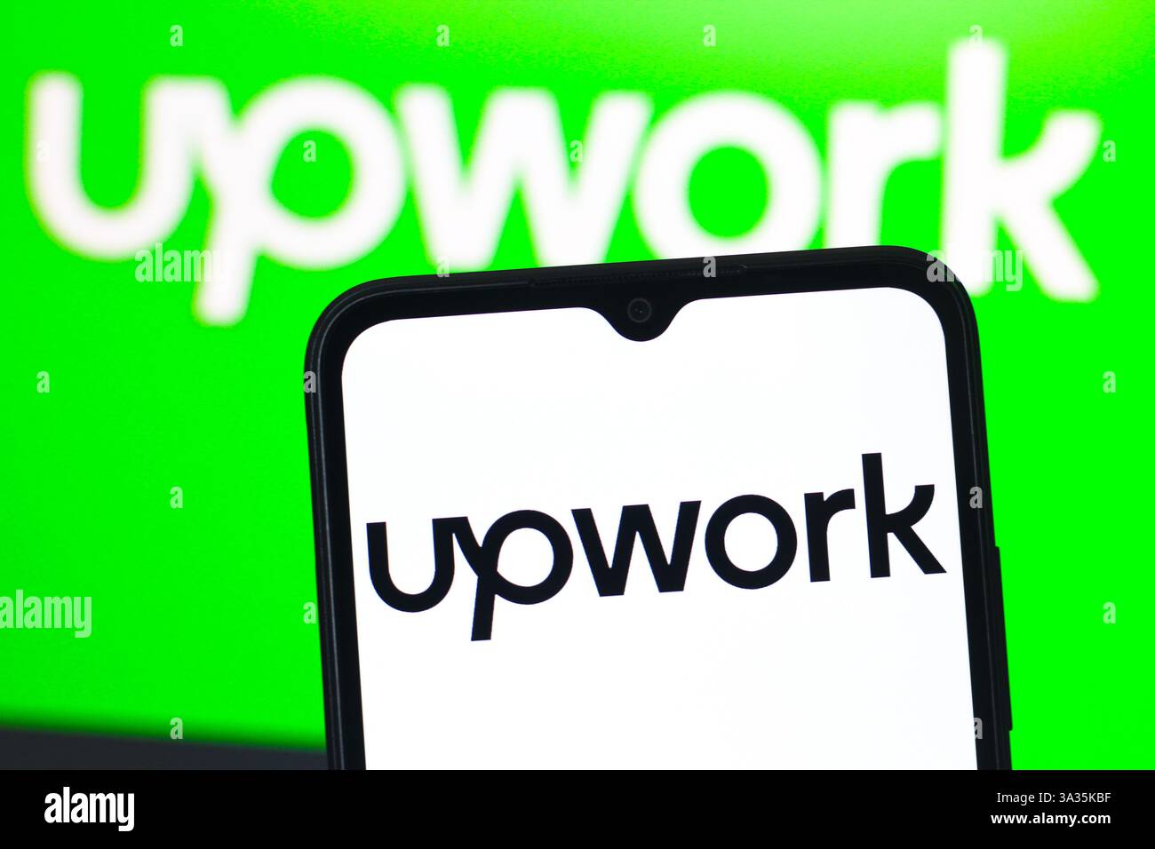 In this photo illustration, the Upwork logo is seen displayed on a smartphone screen Stock Photo ...