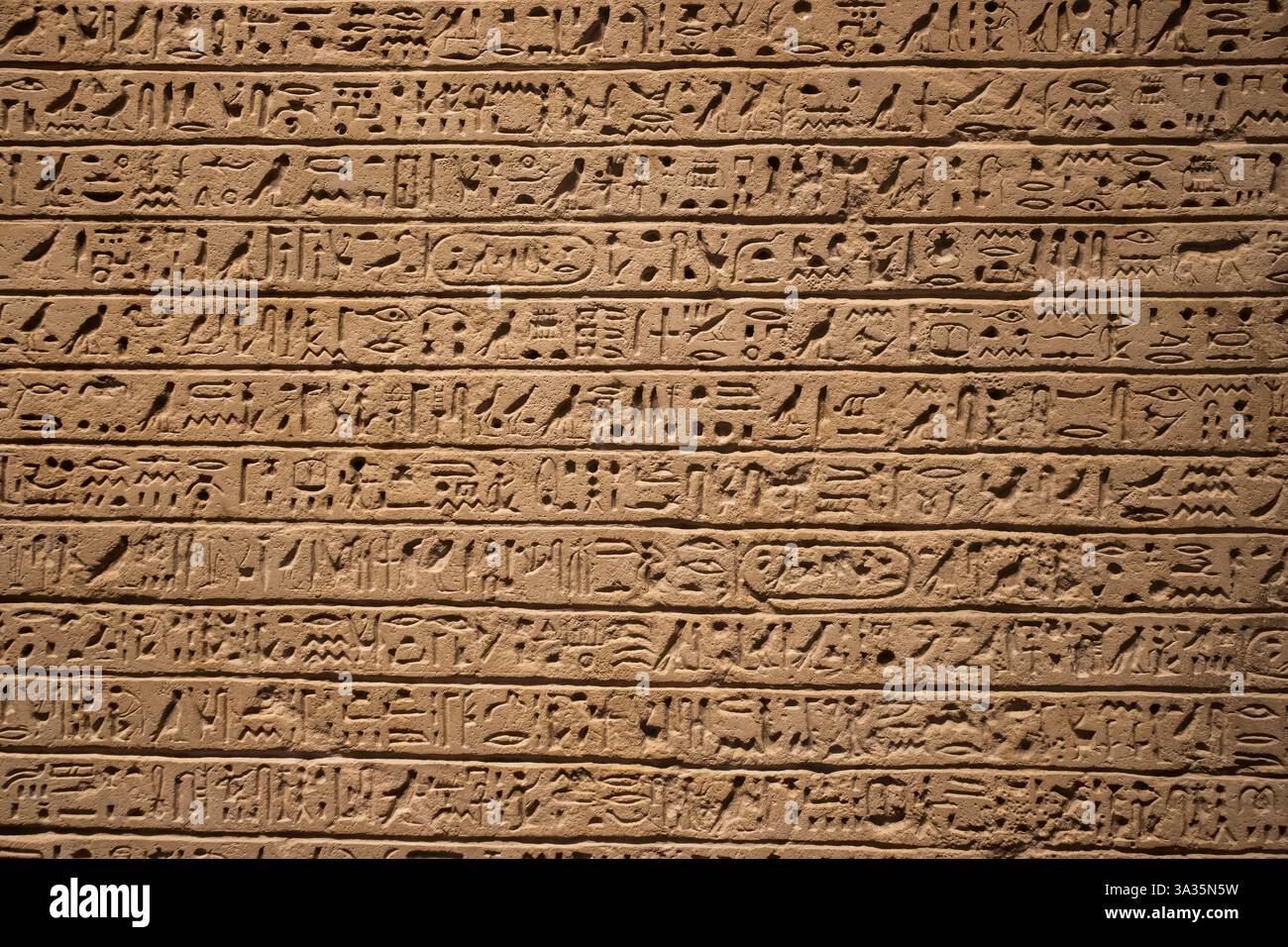 Ancient egyptian hieroglyphs carved on sand stone at the Grand Egyptian ...