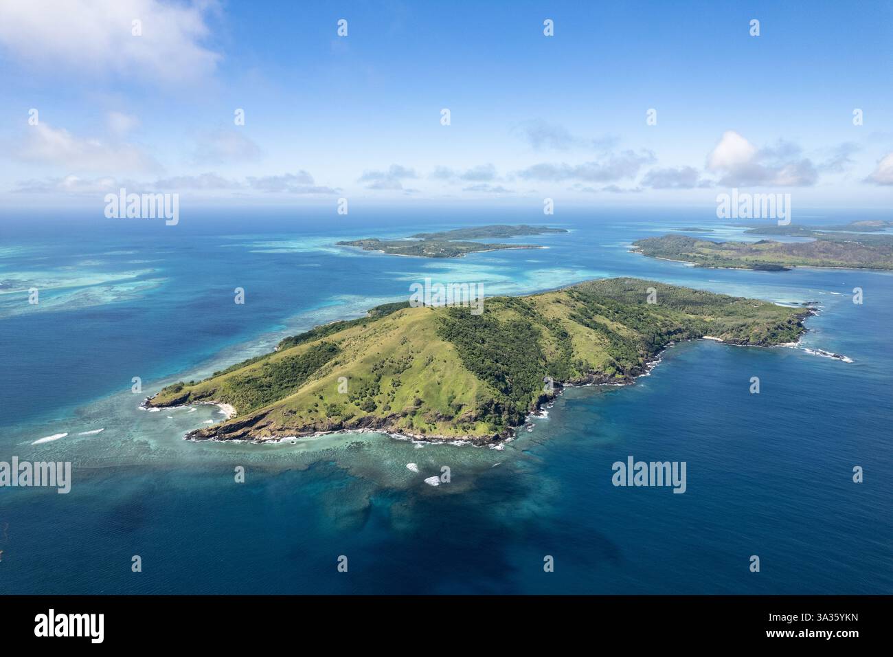 Aerial view of remote Tropical Islands surrounded by Coral Reefs in ...