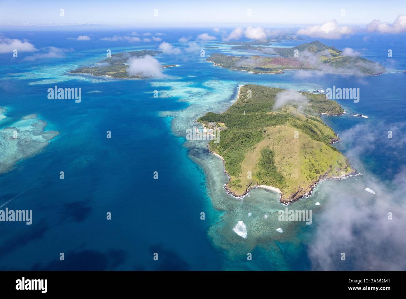 Aerial view of remote Tropical Islands surrounded by Coral Reefs in ...