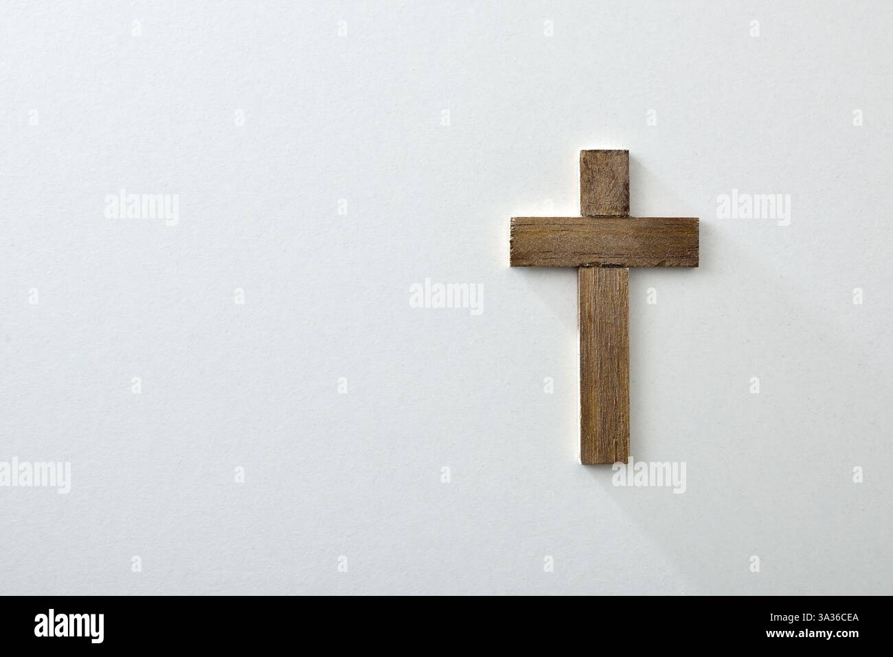 Basic wooden Christian cross isolated on a white table. Top view Stock ...