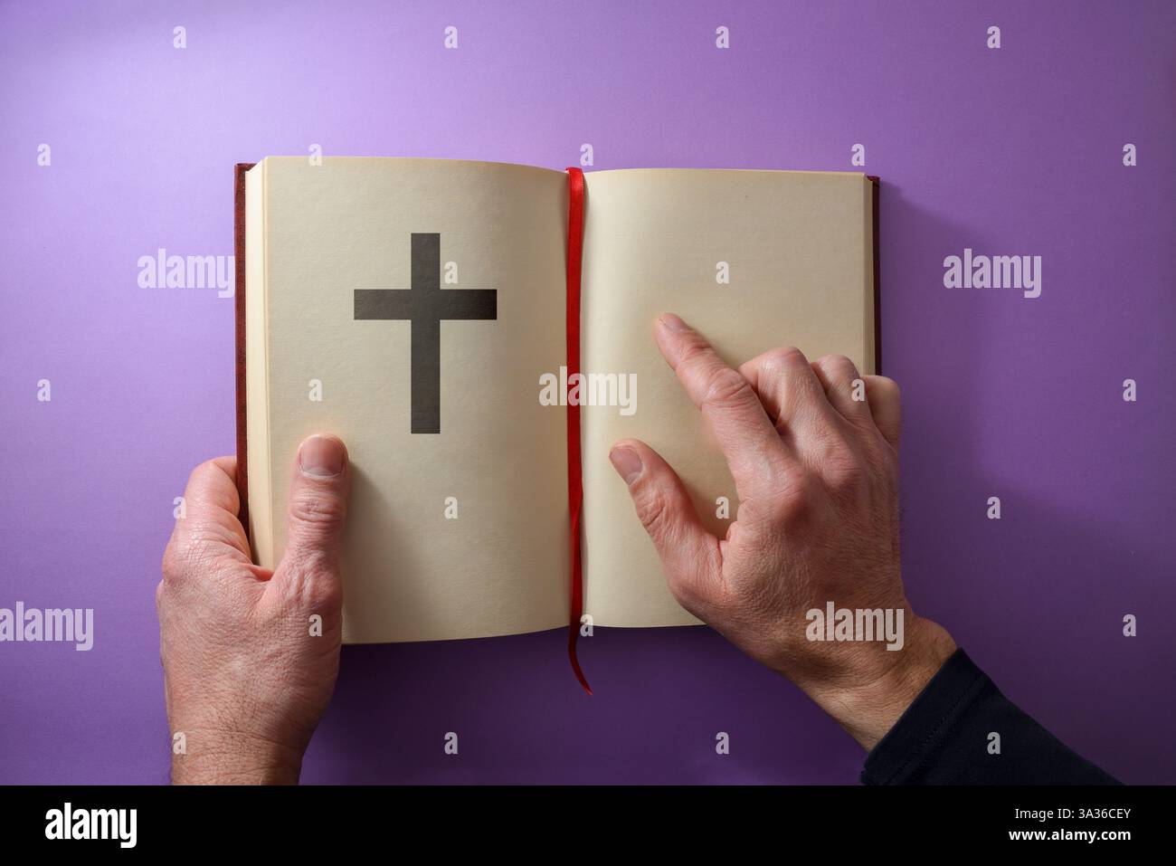 Concept of a Christian religious man reading from an open book with a ...