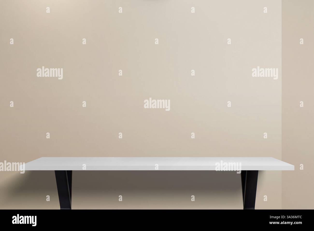 Minimalist white desk with black legs, positioned in the corner of a ...