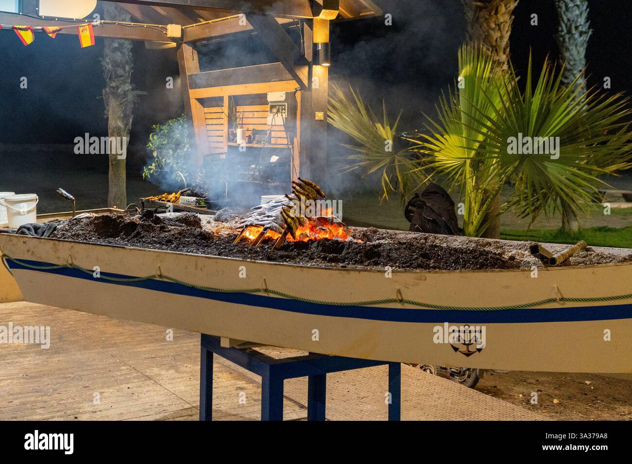 Traditional Espeto skewers are roasting over a wood fire pit inside an ...