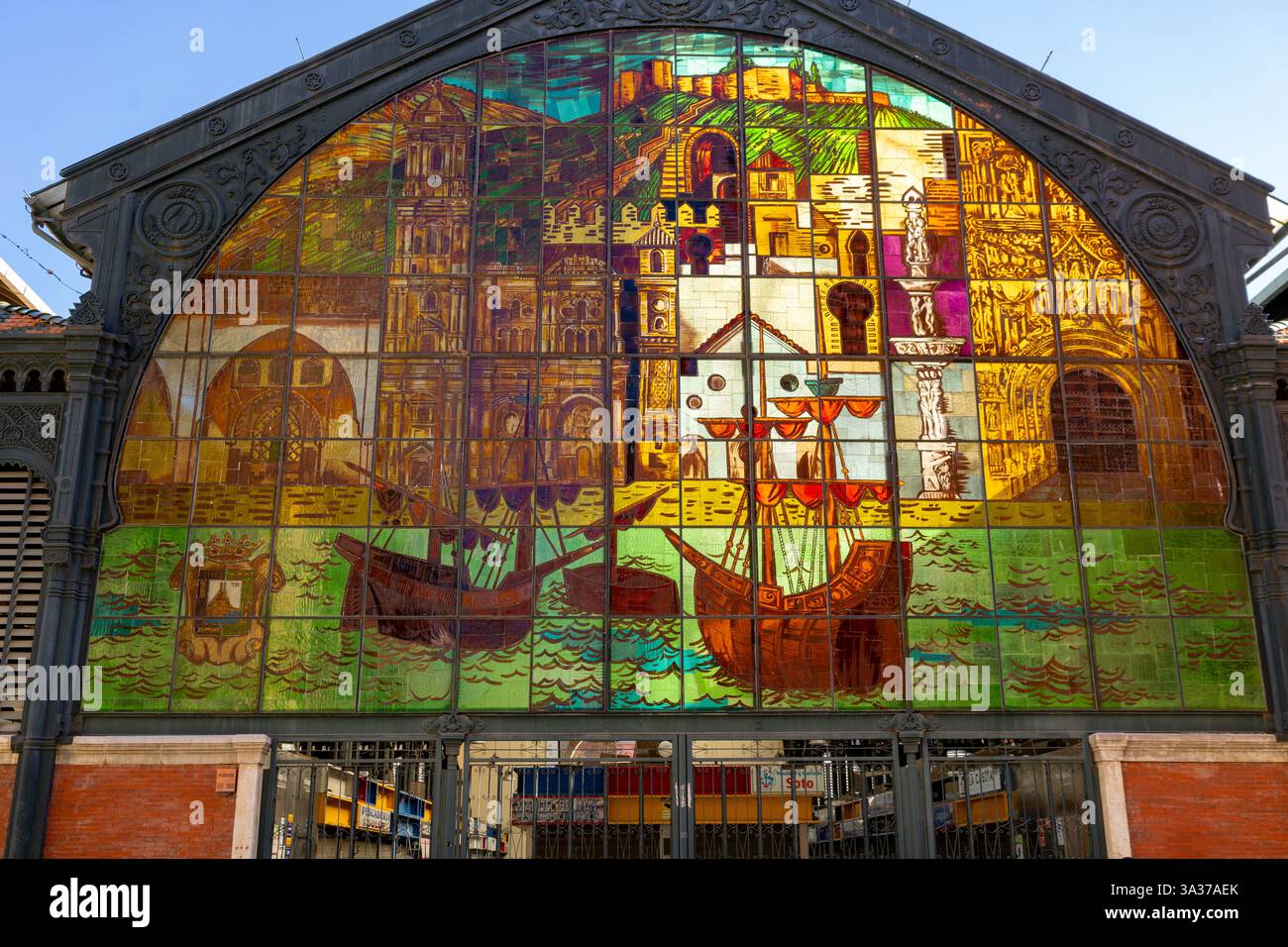 The colorful stained glass depicts ships sailing in front of buildings ...