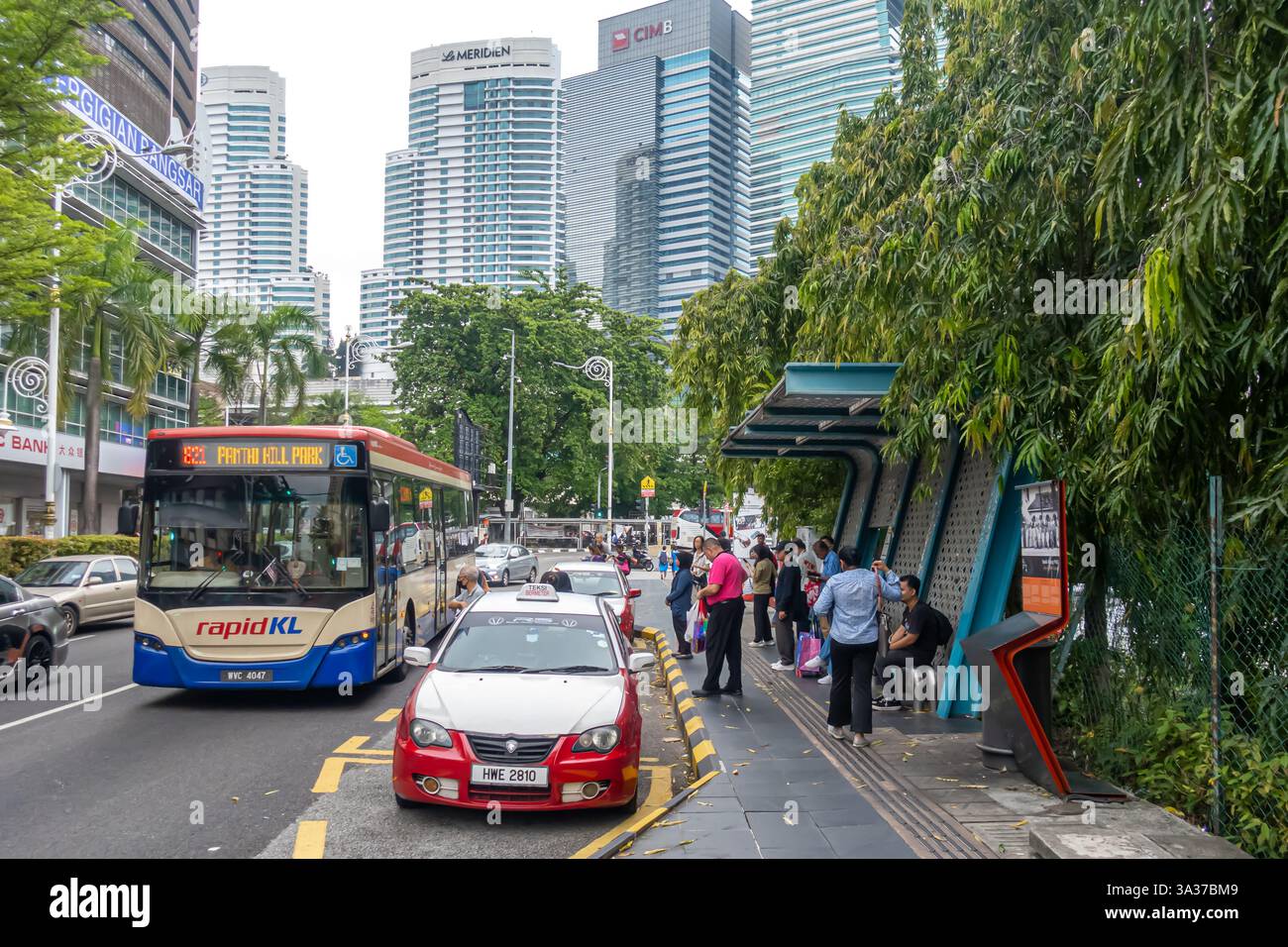 a street scene in Kuala Lumpur, Malaysia. Rapid KL bus and bus stop ...
