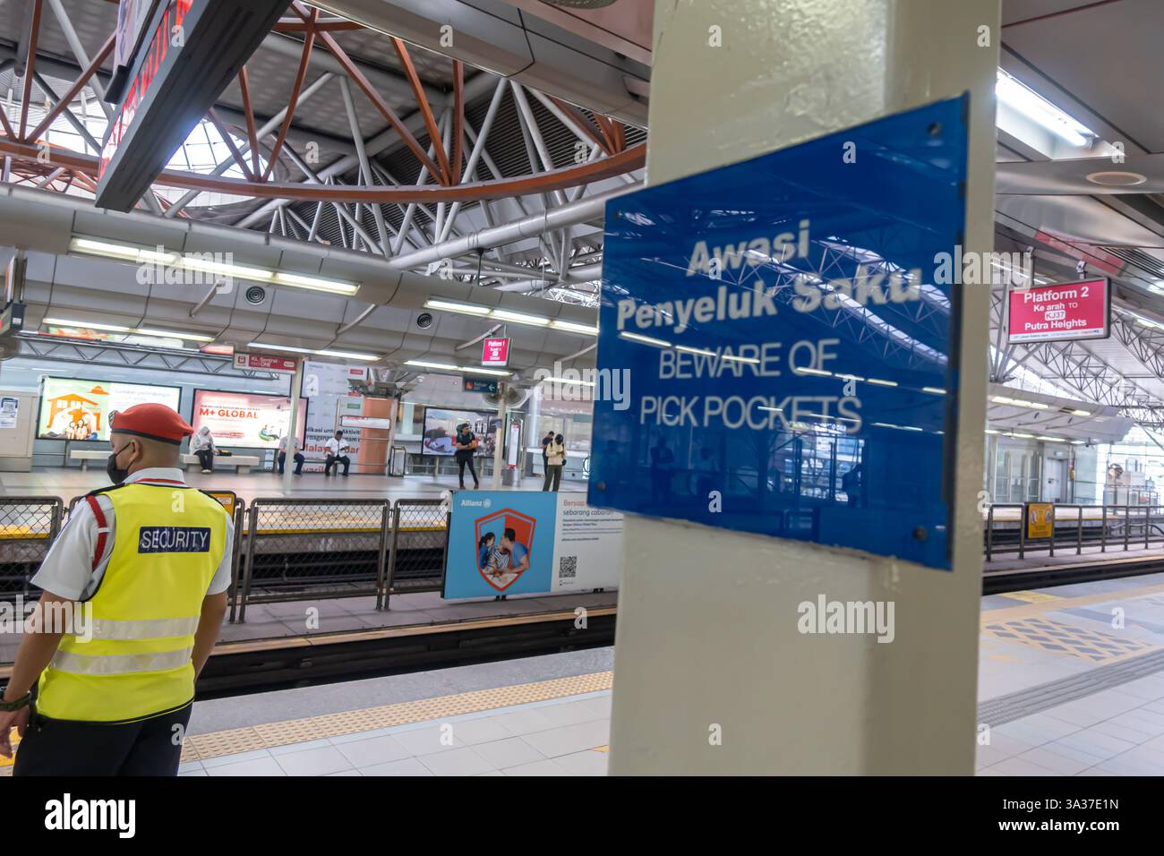 security staff, sign in both English and Malay, warning people to ...