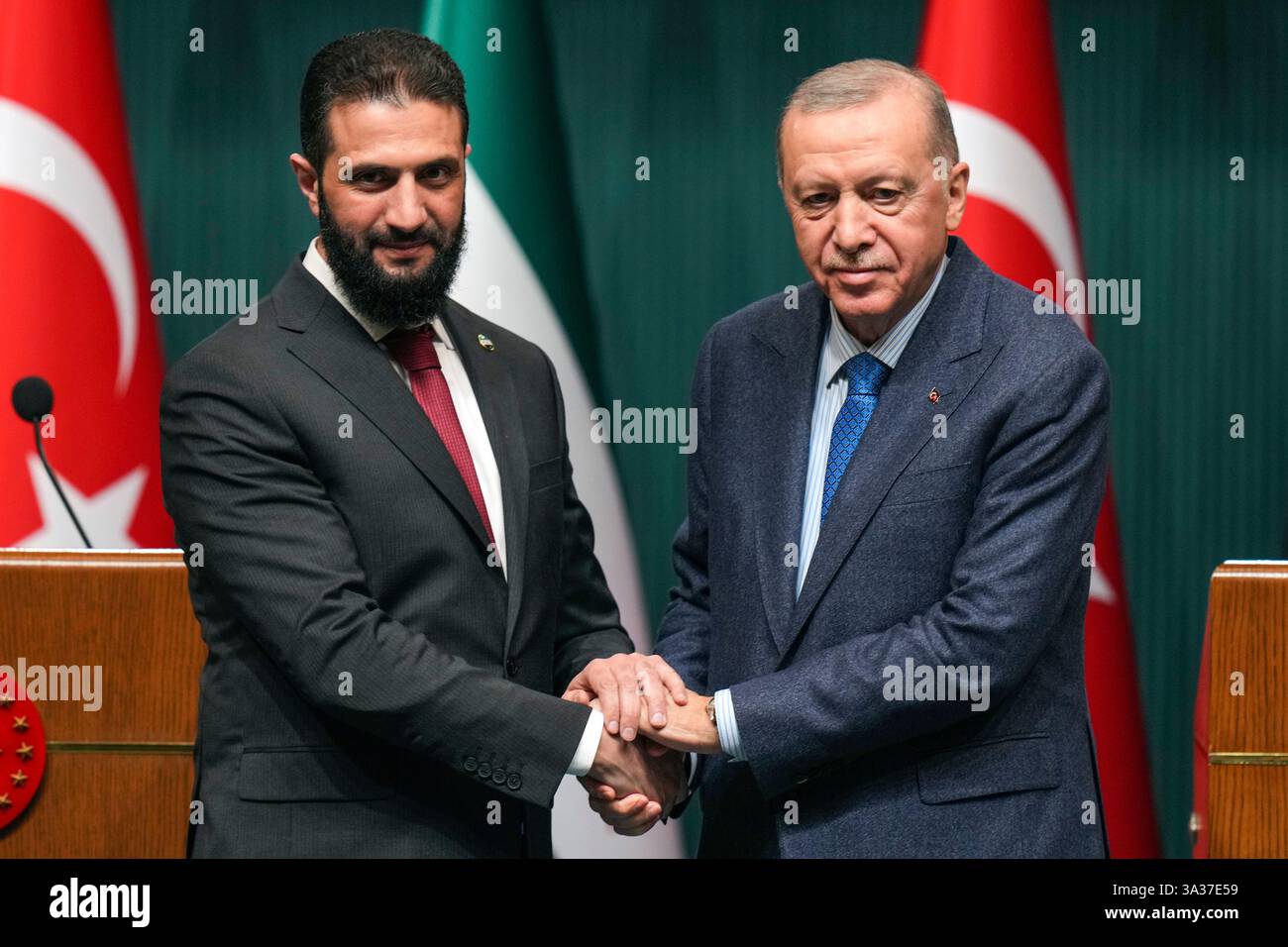 FILE - Turkish President Recep Tayyip Erdogan, right, shakes hands with ...