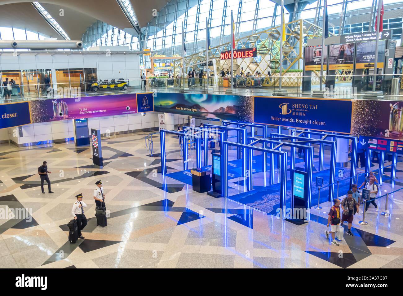 Terminal 1 departures, passenger walkways, signage, and people moving ...