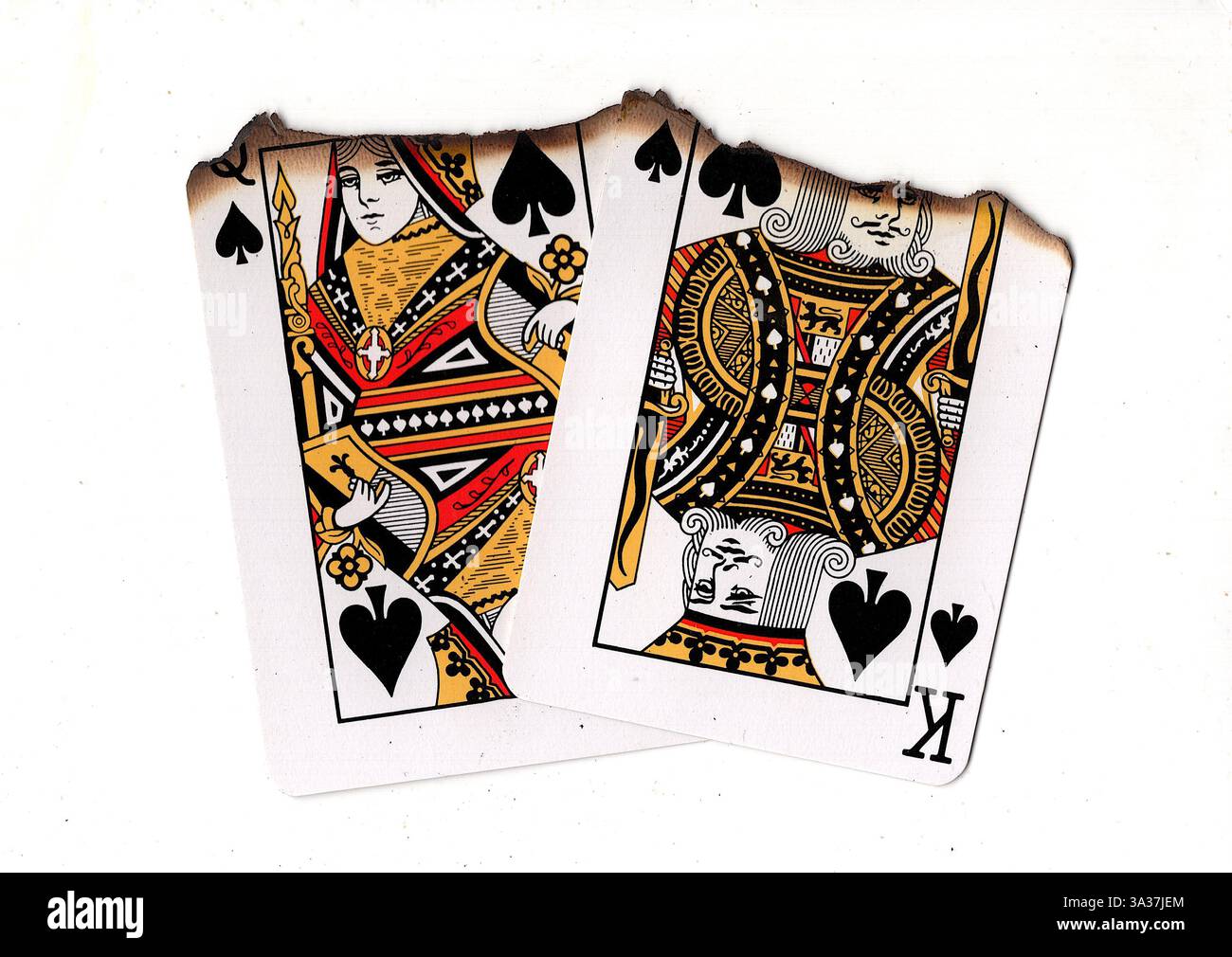 Partly burnt playing cards in the suit of spades isolated on a white ...