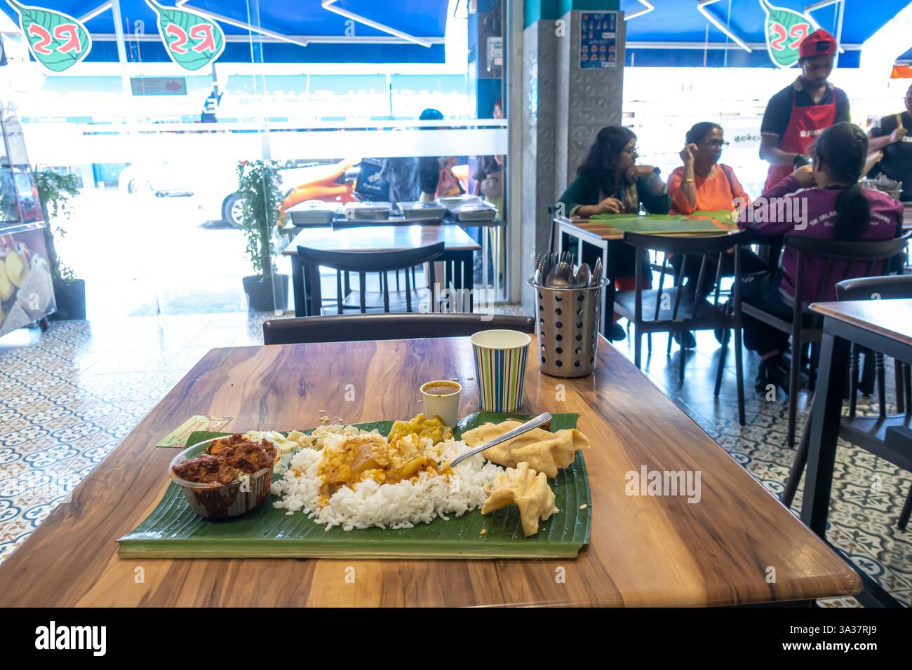 South Indian meal, specifically a banana leaf rice dish, served on a ...