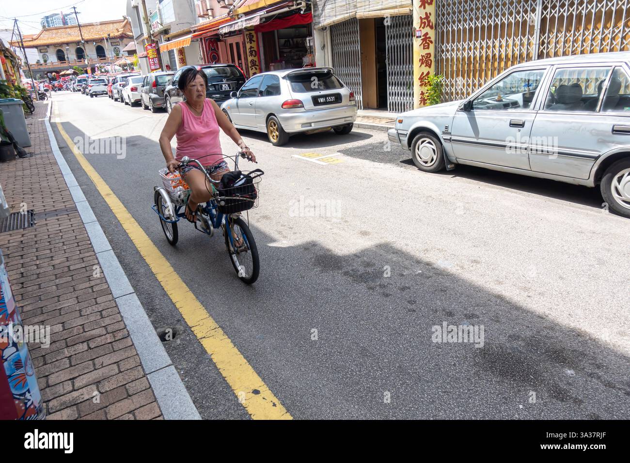 Senior woman riding tricycle hi-res stock photography and images - Alamy