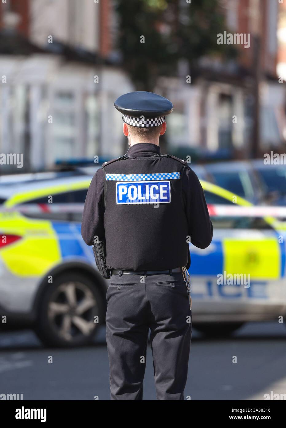 Police officer pictured from behind at a crime scene in the UK Stock ...