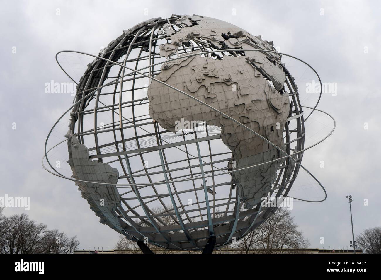 A large, spherical sculpture with a grid pattern and a map of the world ...