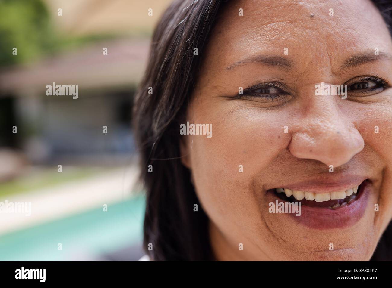 Senior woman by pool, smiling and relaxing on sunny day outdoors Stock ...