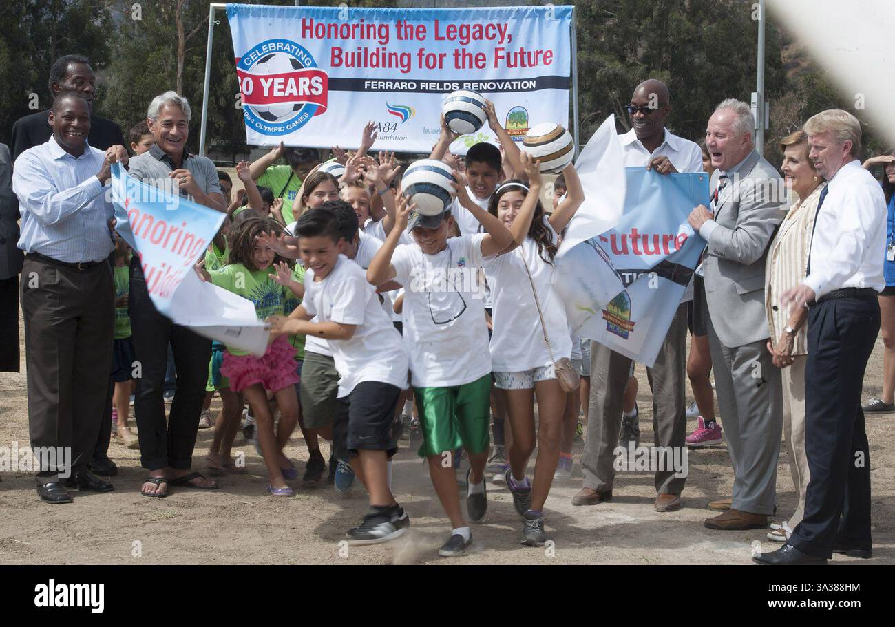 July 28, 2014 - Los Angeles, CA, USA - Children run through a banner ...