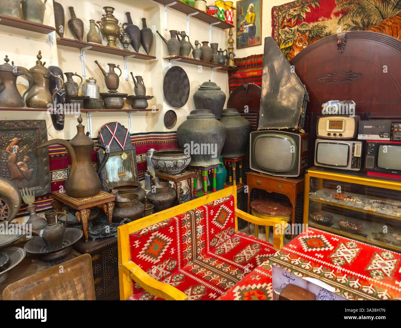 A vintage shop interior with antique items including old televisions ...