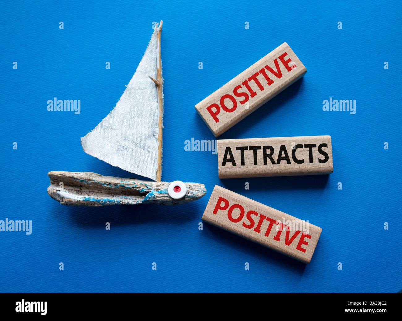 Positive attracts Positive symbol. Wooden blocks with words Positive ...