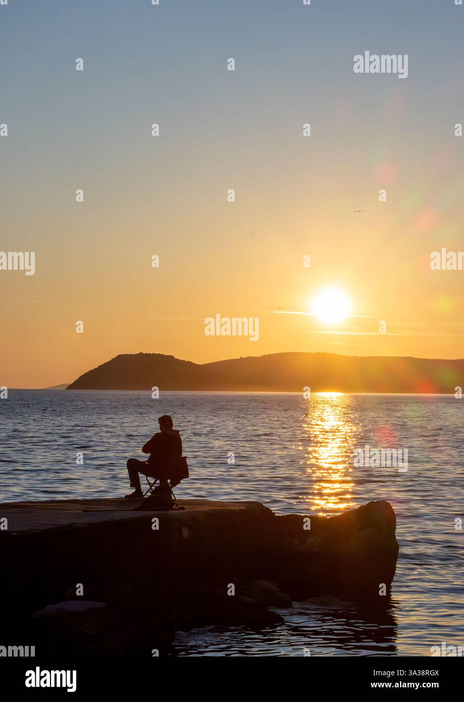 Silhouette of elderly person fishing.Concept of hobbies and relaxation ...