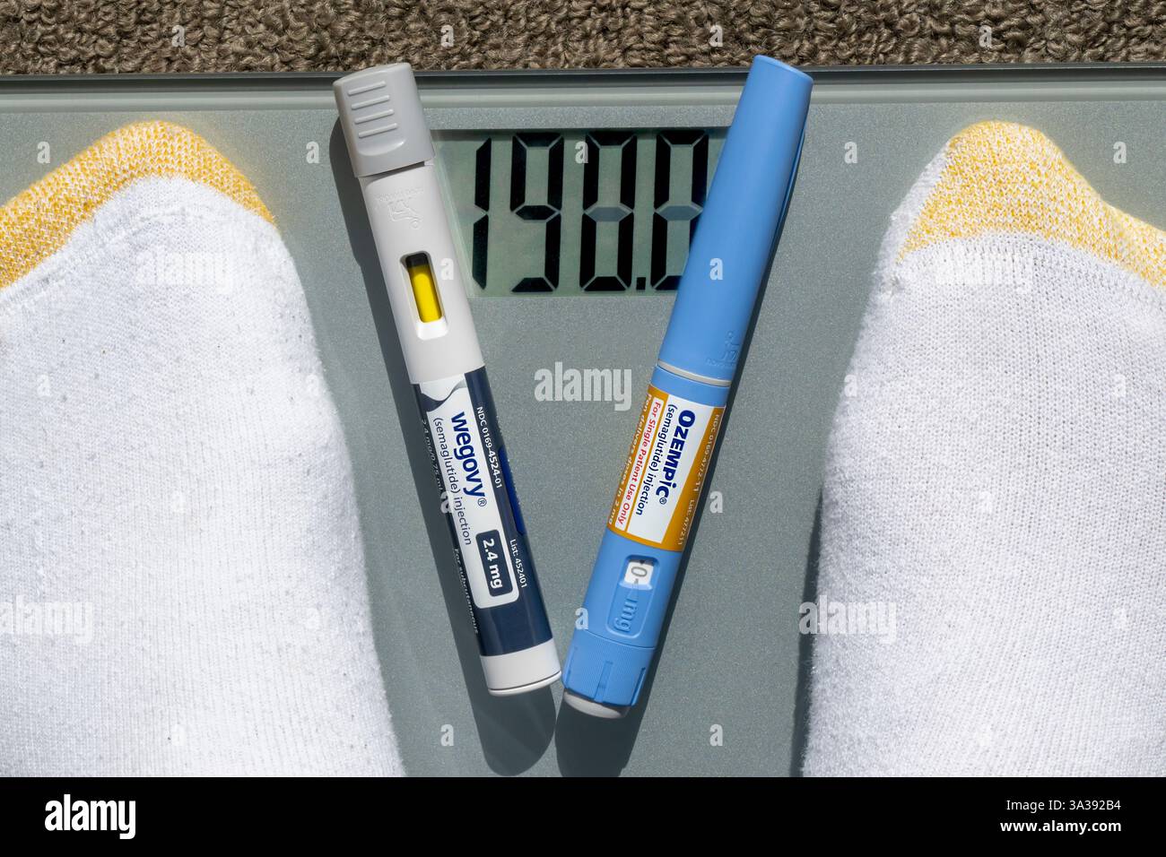 Still life of Ozempic and Wegovy with weight scale. Both are injectable ...