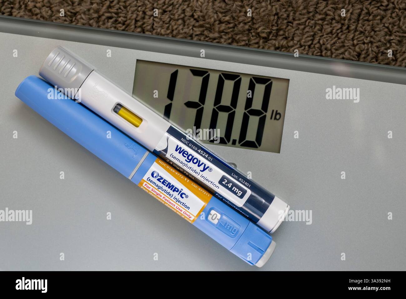 Still life of Ozempic and Wegovy with weight scale. Both are injectable ...