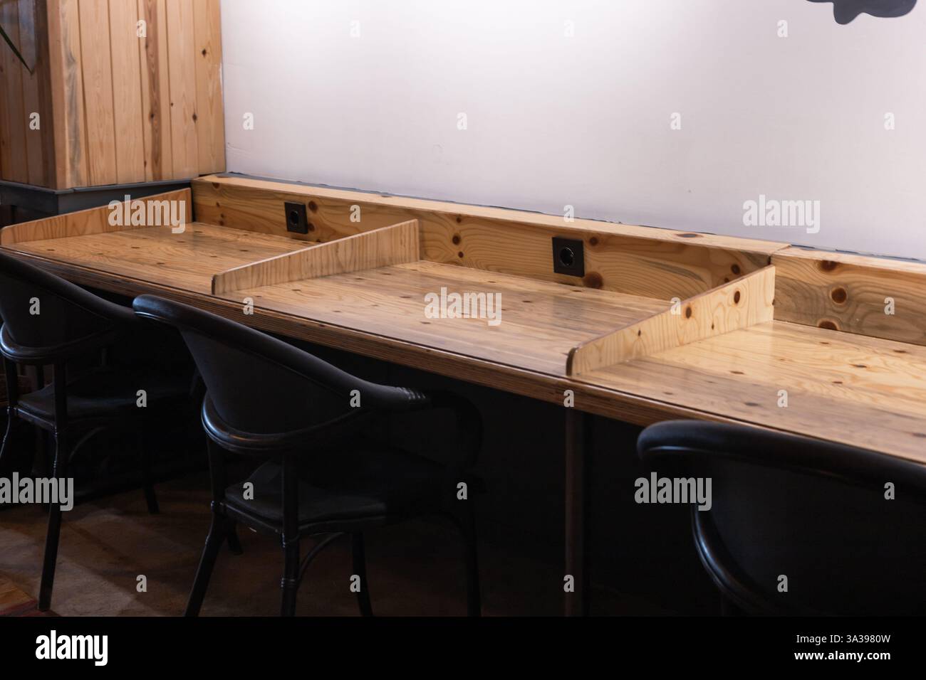 Comfortable seating area showcases wooden tables with integrated ...