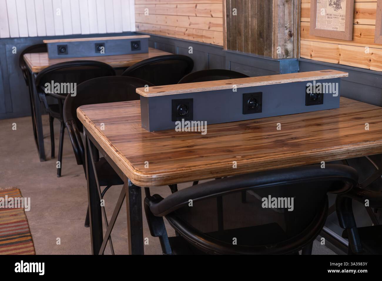 Comfortable seating area showcases wooden tables with integrated ...