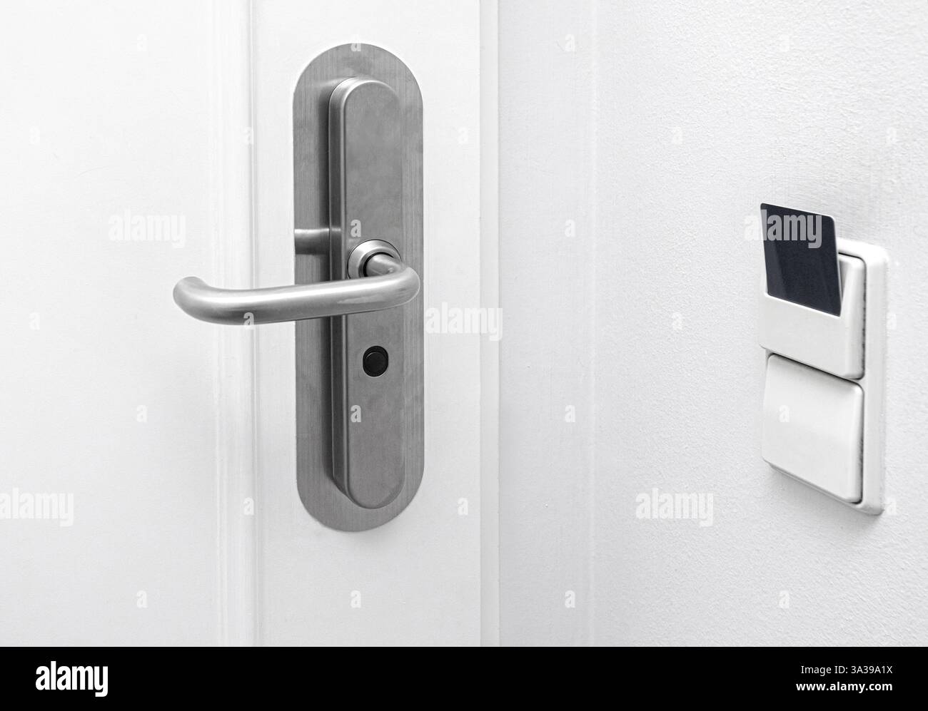 Key card inserted in a hotel room door lock with light switch, concept ...