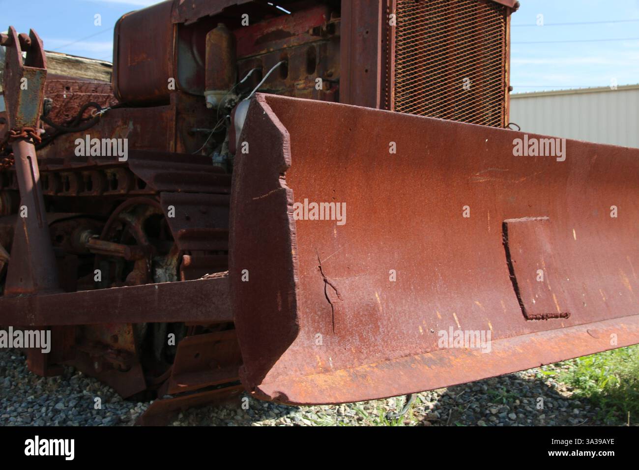 The steel blade on Aa old, well used, rusted bulldozer, now abandoned ...
