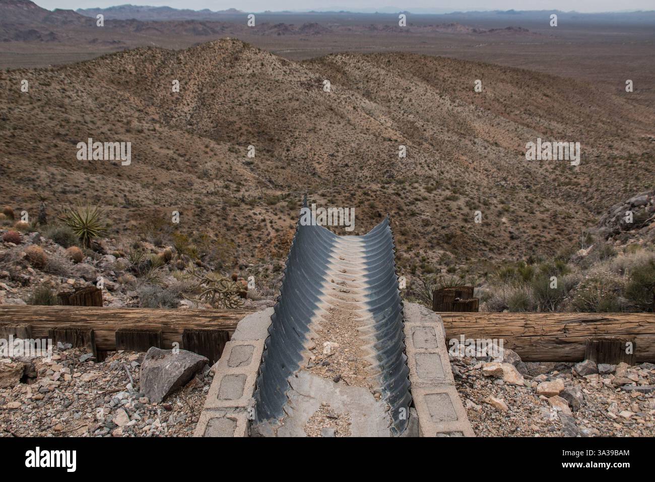 A corrugated drainage pipe directs water runoff over the side of a ...