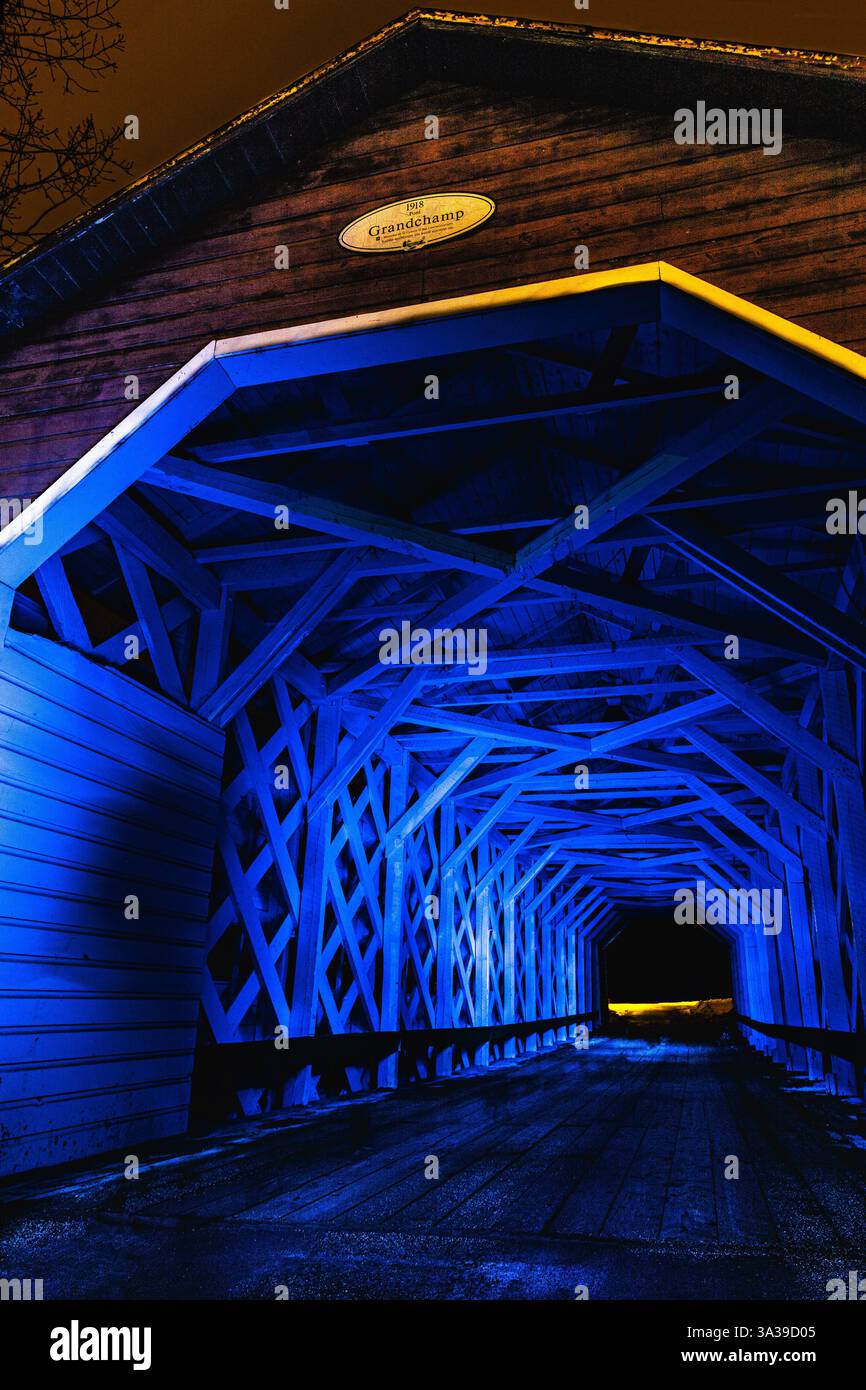 An antique wooden bridge illuminated through light painting, creating a ...