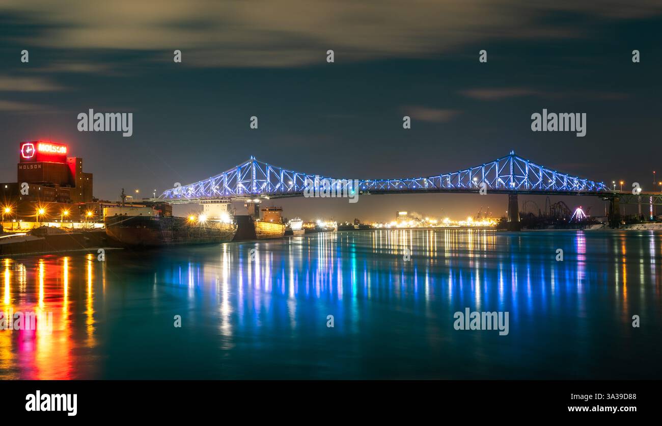Night view of the Saint Lawrence River with the illuminated Jacques ...