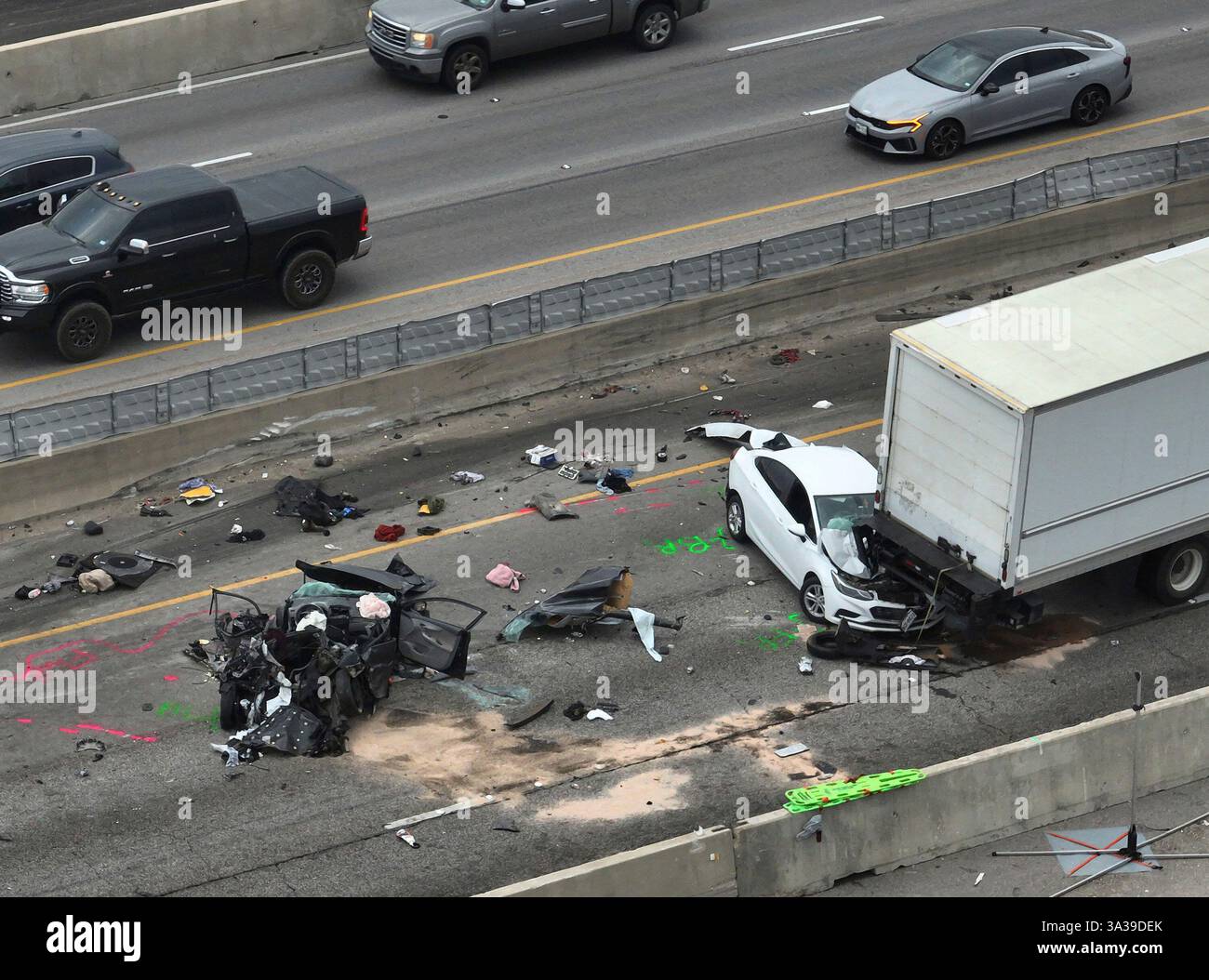 Officials examine the aftermath of a fatal crash on I-35 southbound ...