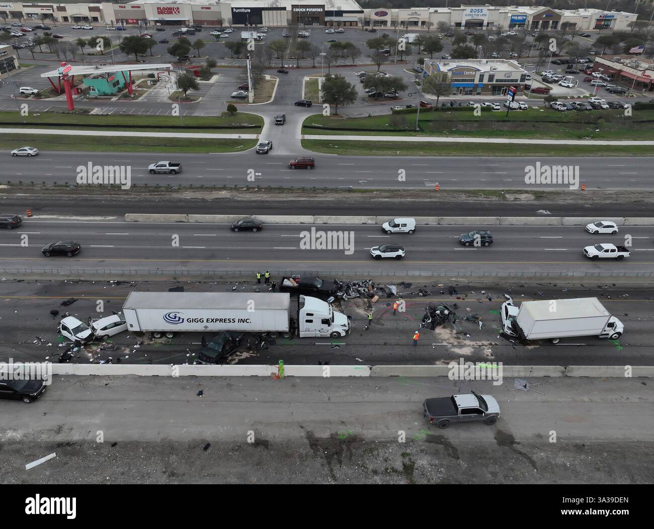 Officials examine the aftermath of a fatal crash on I-35 southbound ...