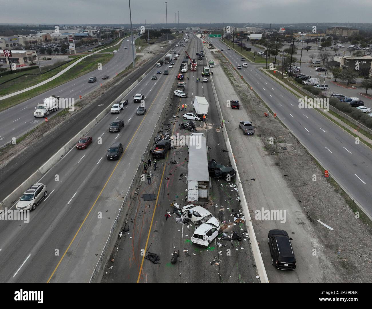 Officials examine the aftermath of a fatal crash on I-35 southbound ...