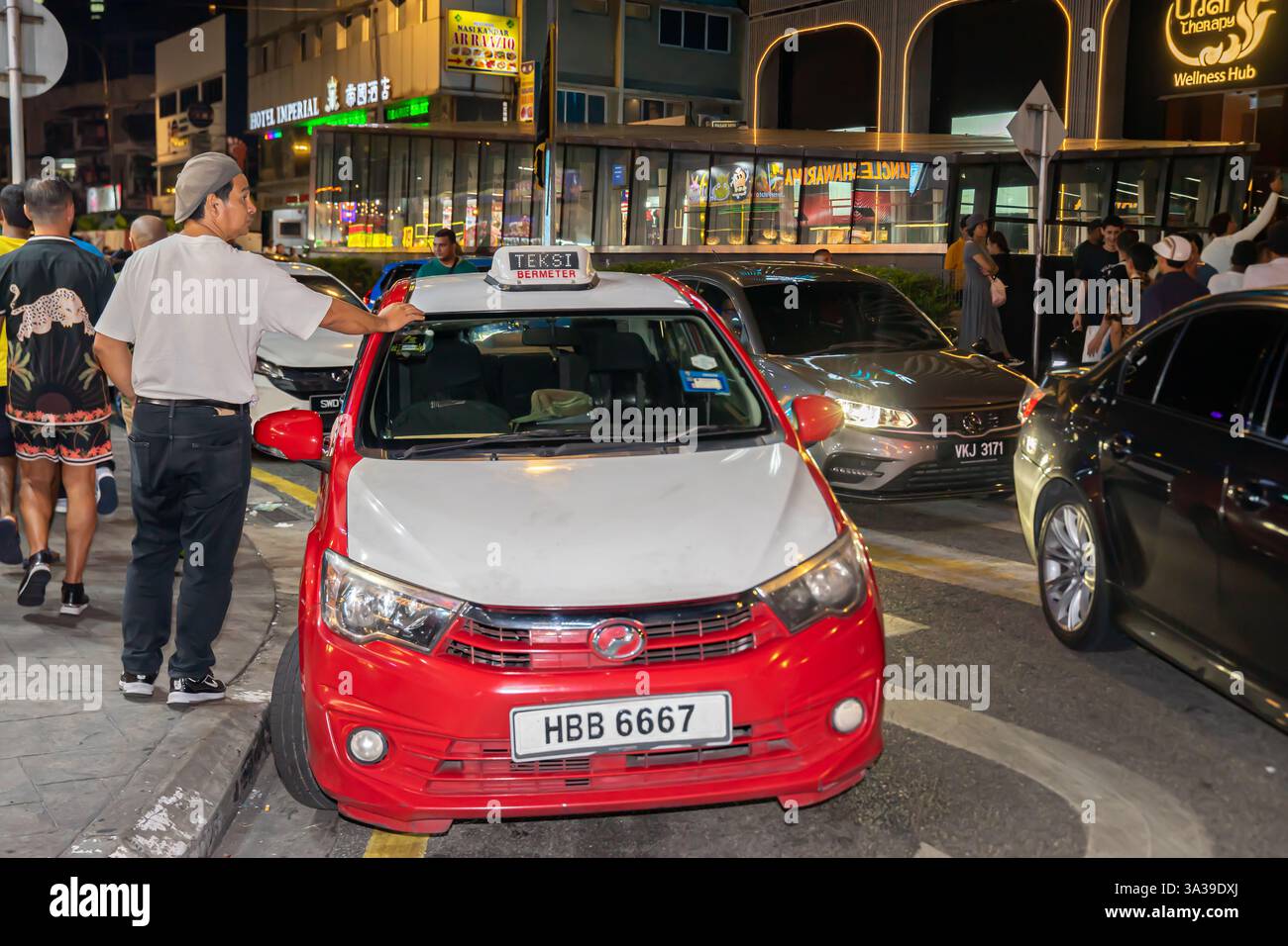 Taxi driver beside his cab car, Jln Bukit Bintang, Bukit Bintang, night ...