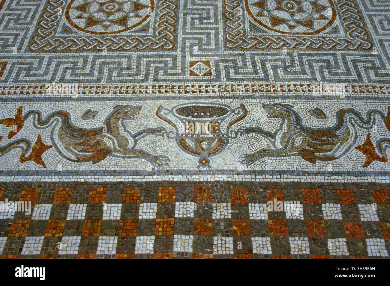 Hybrid sea monsters with clawed feet flank an urn or krater in the late ...