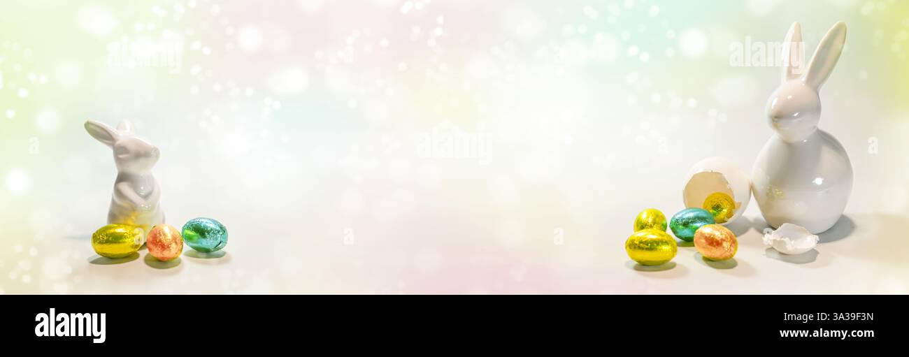 Two white ceramic Easter bunnies left and right with small colorful ...