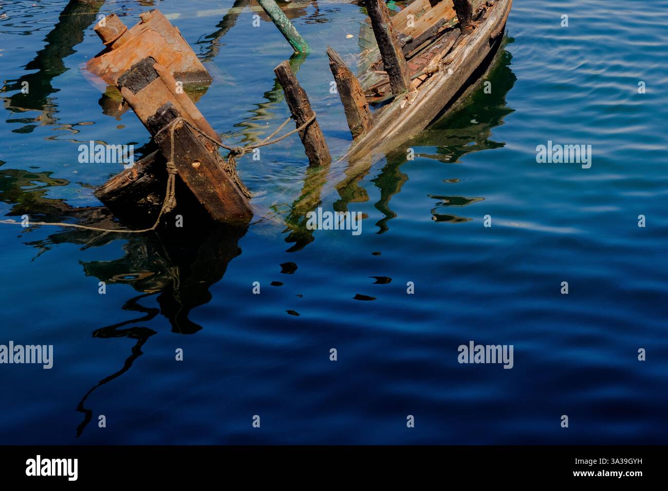 Colour photograph of a sunken partially submerged wooden boat in the ...