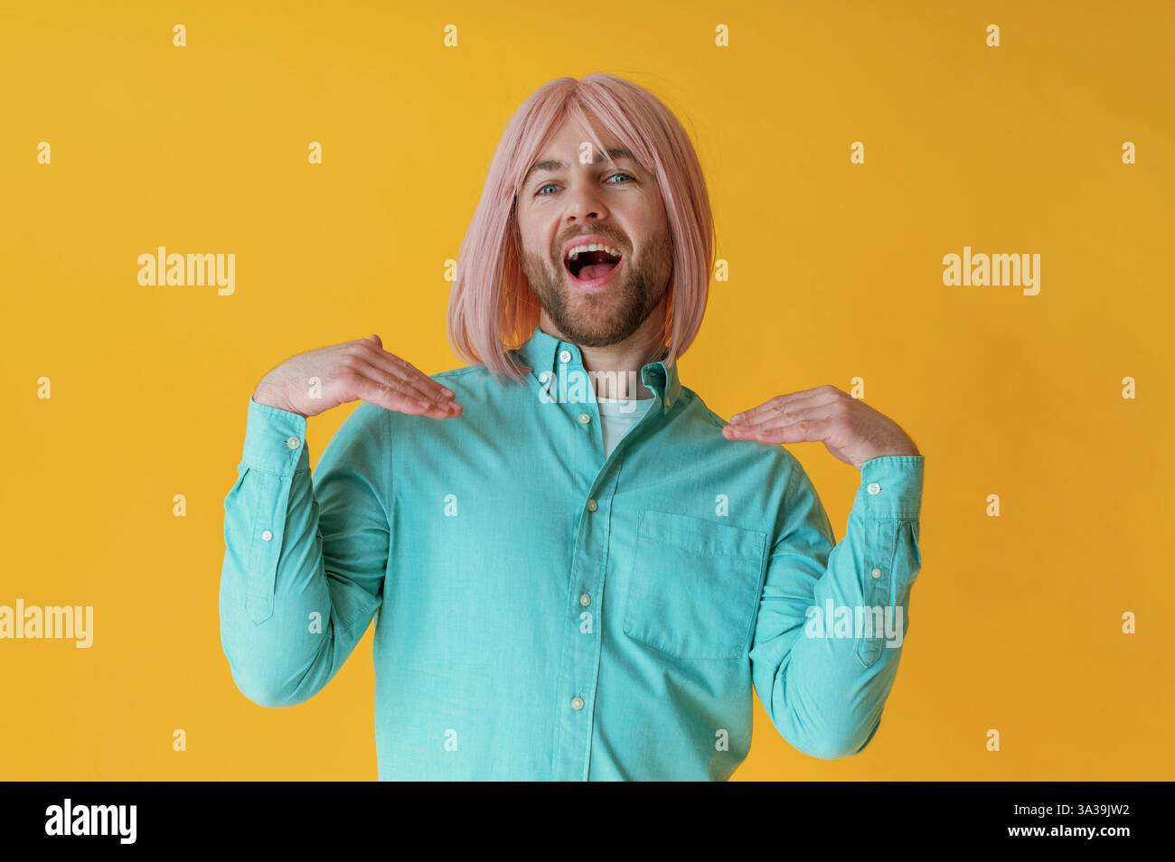 Making facial expression, hand gestures. Guy with pink hair is posing ...