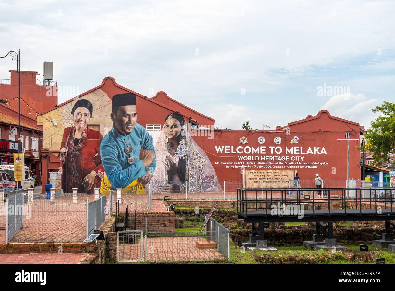 Mural showing traditionally dressed men and women of Malaysia and text ...