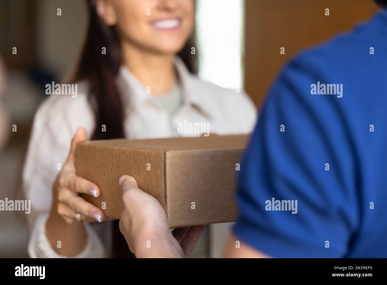 Female customer taking parcel from delivery logistic service worker man ...