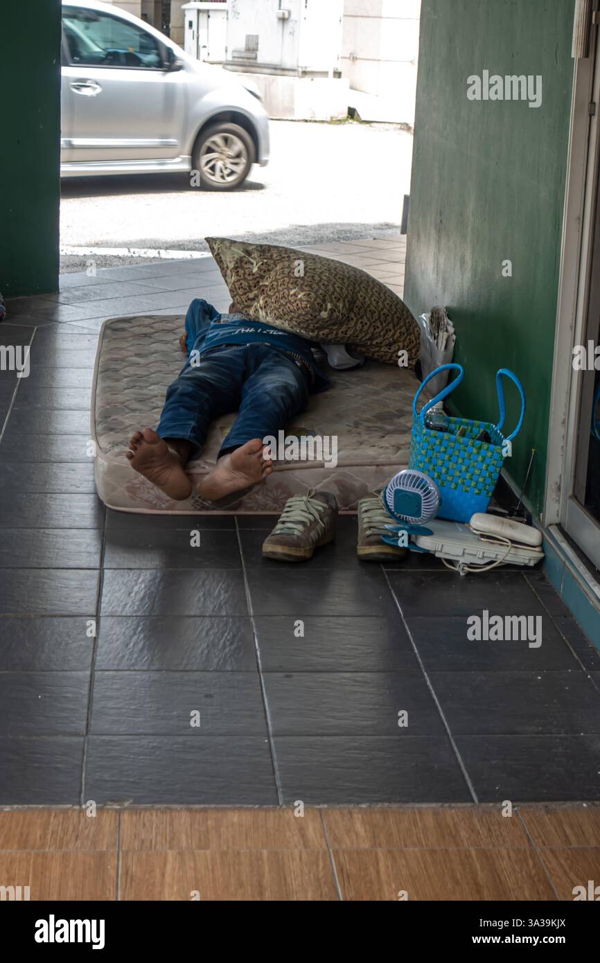 Homeless man sleeping on the doorway floor, Malacca, Malaysia Stock ...