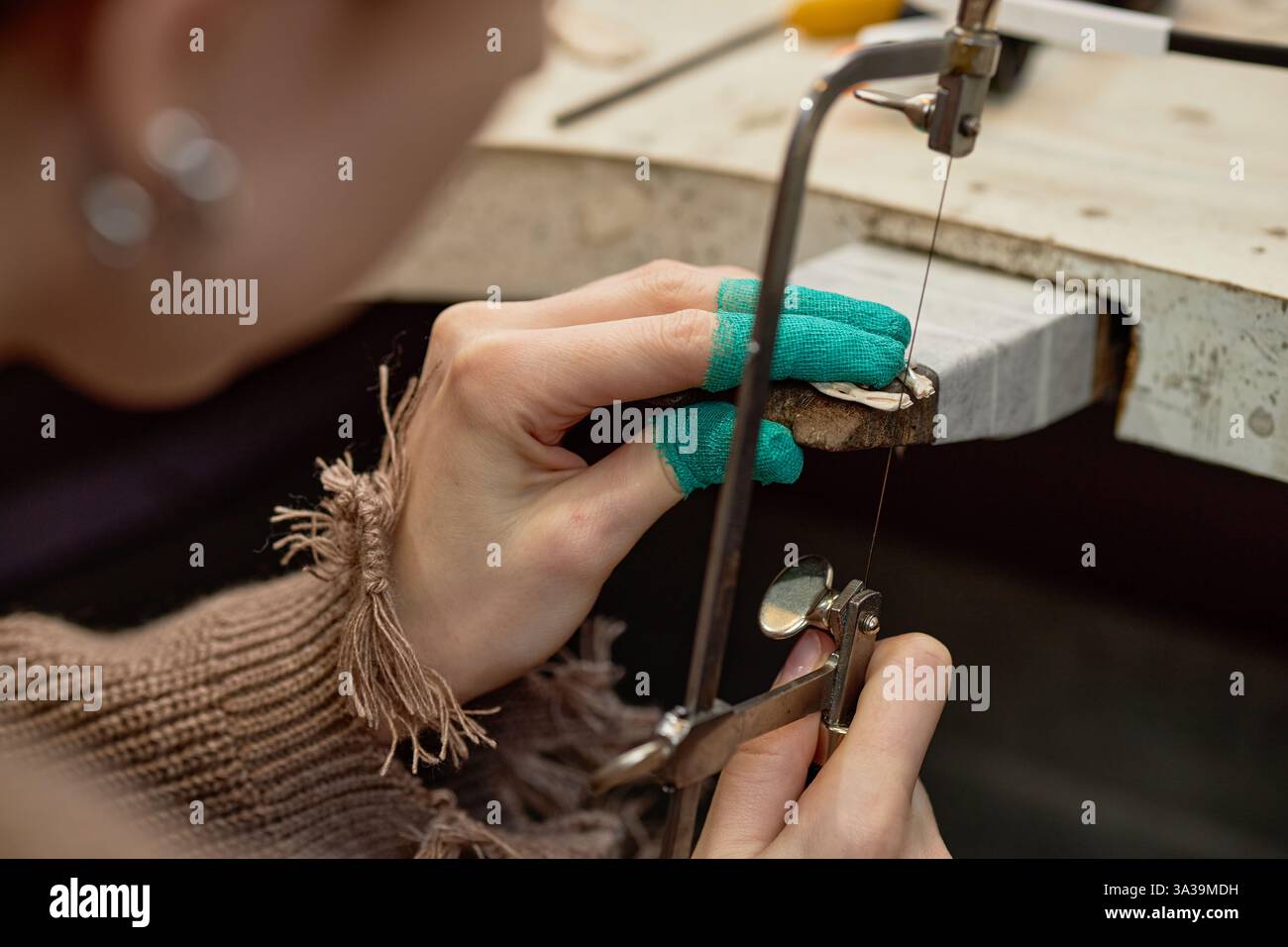 Close-up shot showing precise work while cutting piece of material with ...