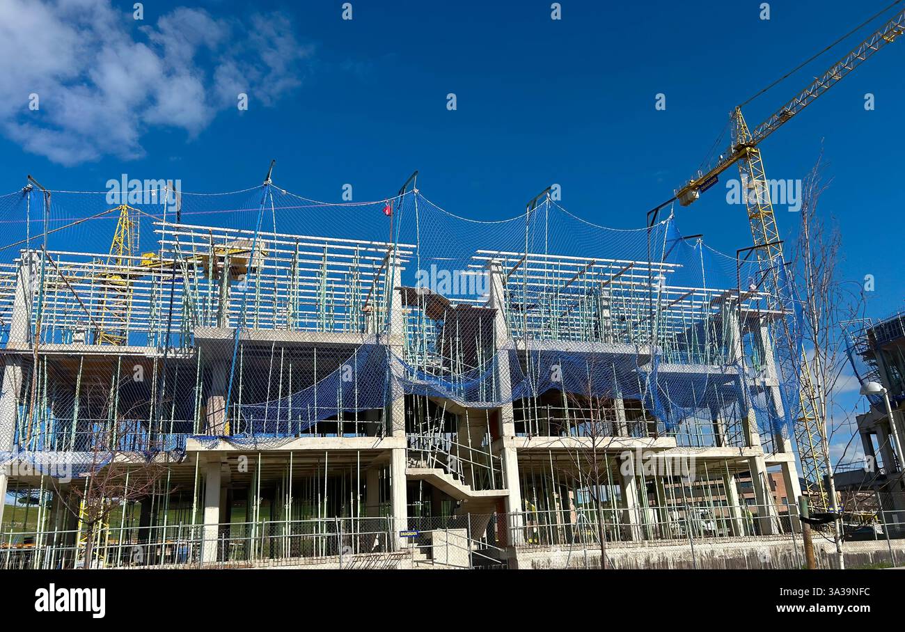 View of the construction site of an apartment building with cranes and ...