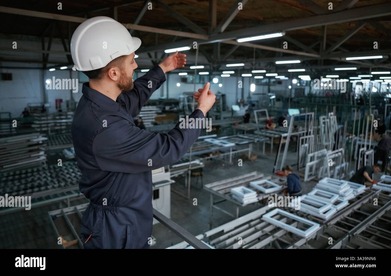 Quality control. Factory worker is indoors with hard hat Stock Photo ...