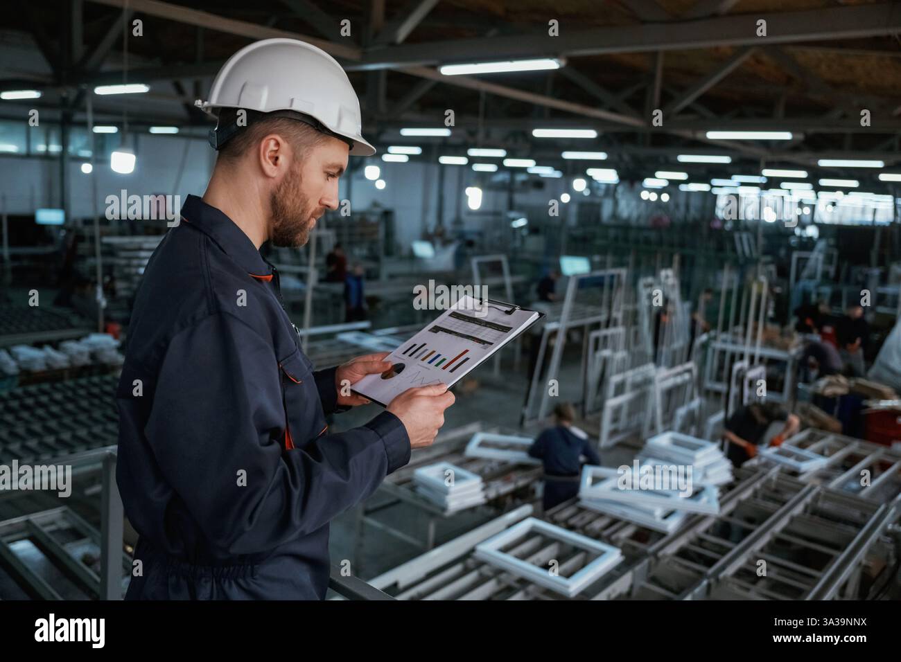 Quality control. Factory worker is indoors with hard hat Stock Photo ...