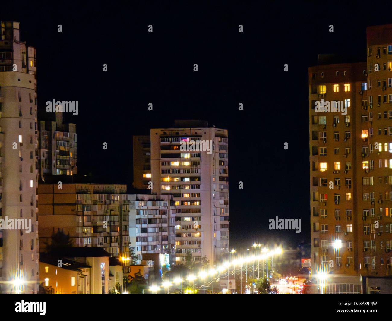 Downtown area comes alive at night with bright streetlights and windows ...